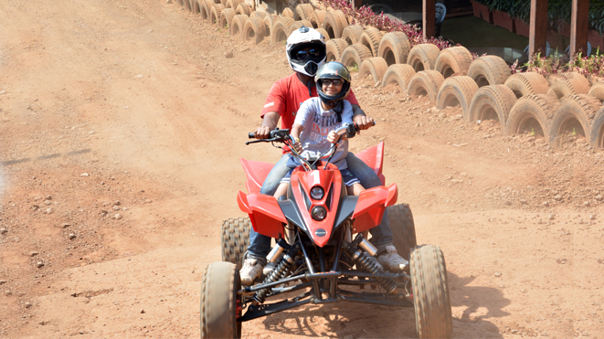 Ride ATV through a rough terrain and feel the thrill at Della Adventure